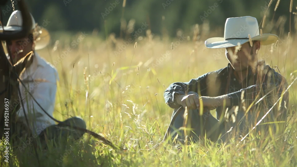 Cowboys relaxing in the grass Stock Video | Adobe Stock