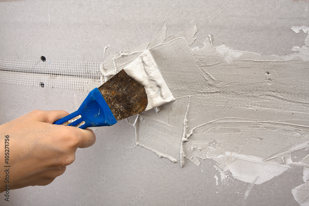 hand coating wall of plaster with spatula Stock Photo | Adobe Stock