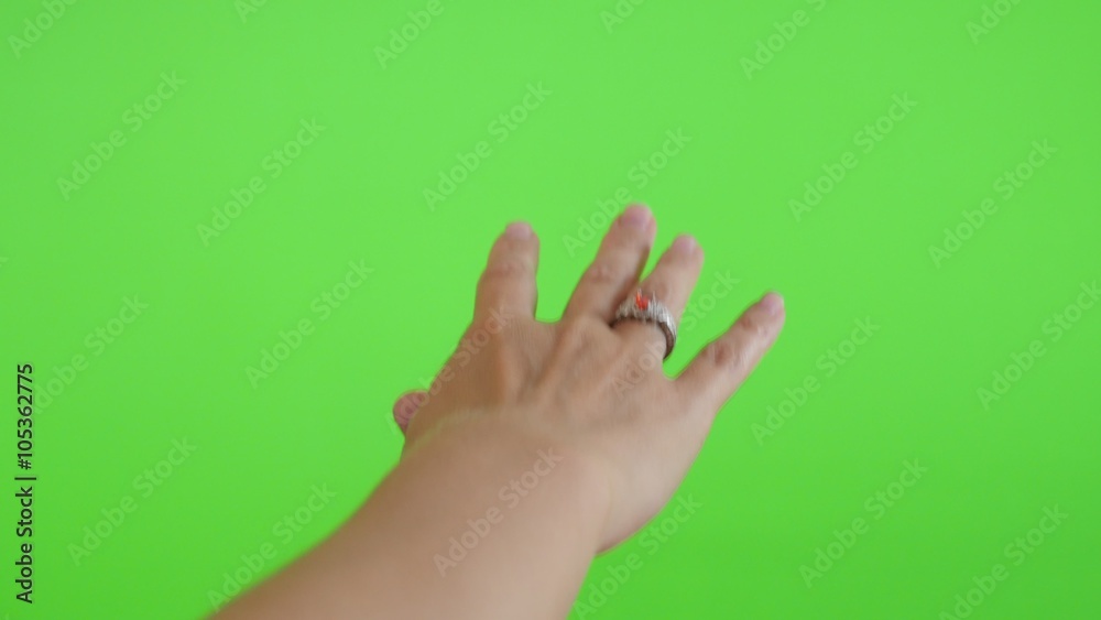 Silver ring with red stone on woman hand in front of green screen ...