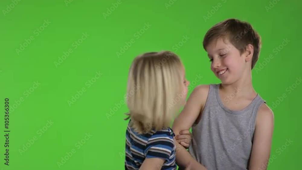 Two brothers are playing together in front of greenscreen Stock Video ...