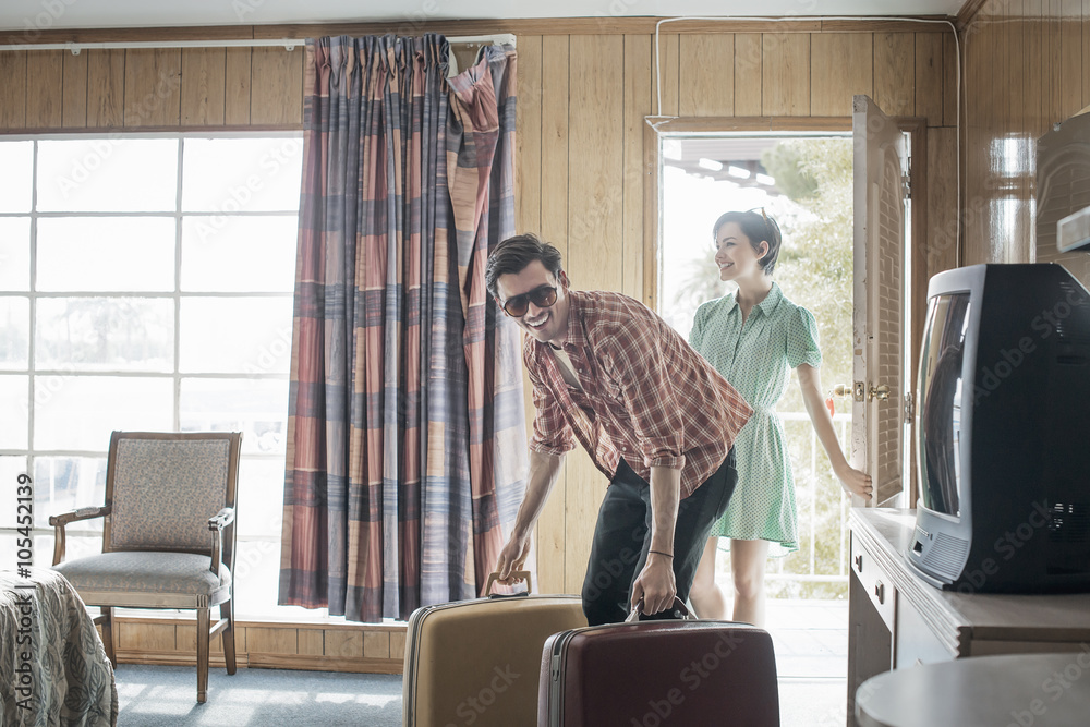 A young couple arriving in a motel room, Stock Photo | Adobe Stock