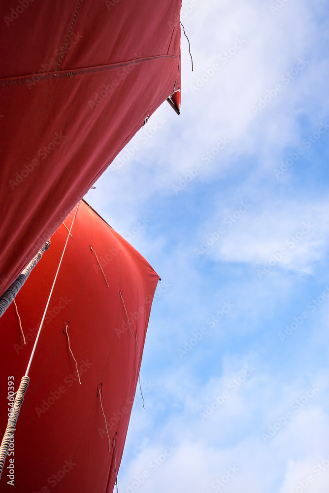 ocher sails filled by the wind on an old rigging sailing boat with ...
