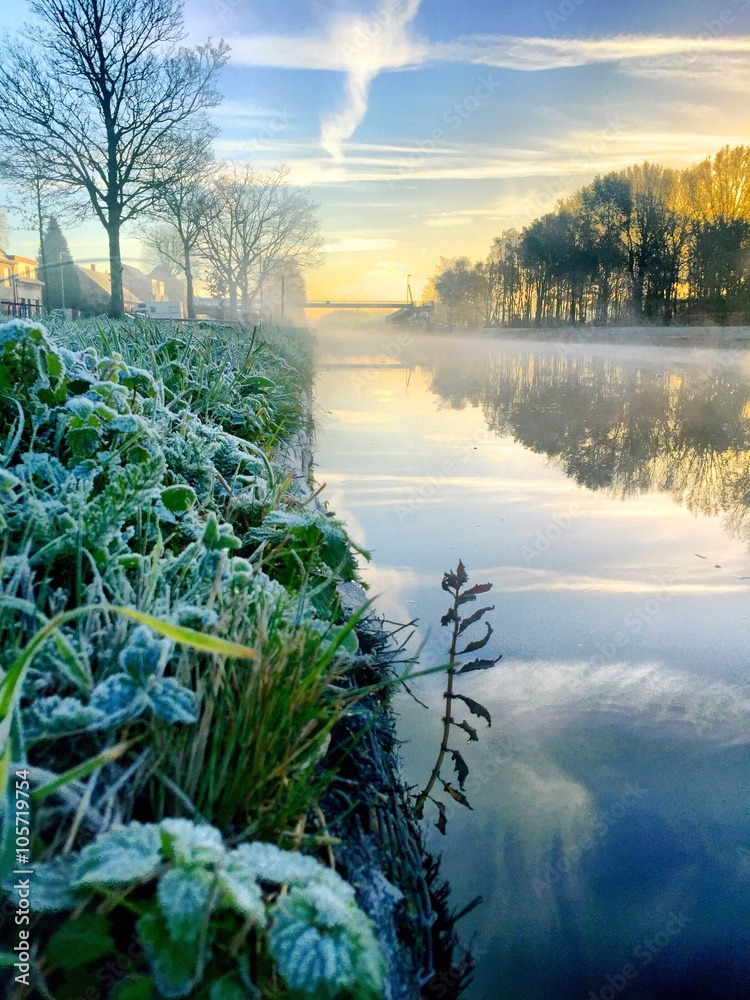 Vivid sunrise over the frosted quay of the river Stock Photo | Adobe Stock