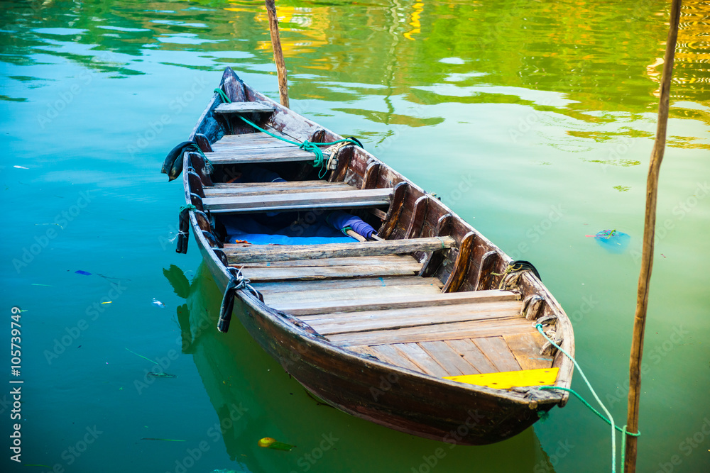 Traditional boats in front of ancient architecture in Hoi An, Vietnam ...
