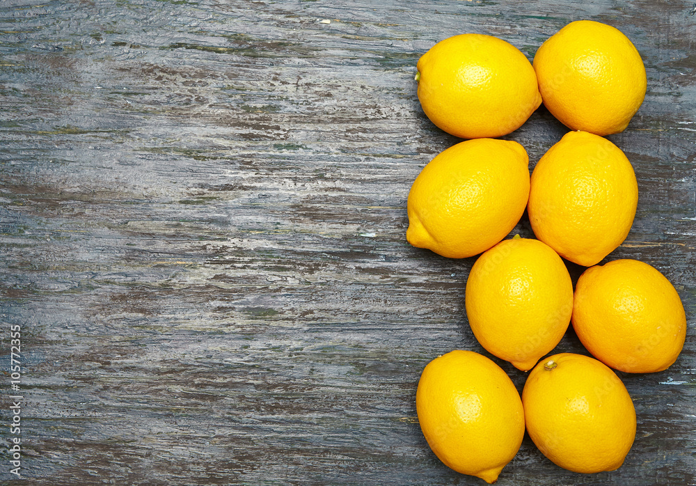 Food background . Fresh lemons in the jar on the old wooden table ...
