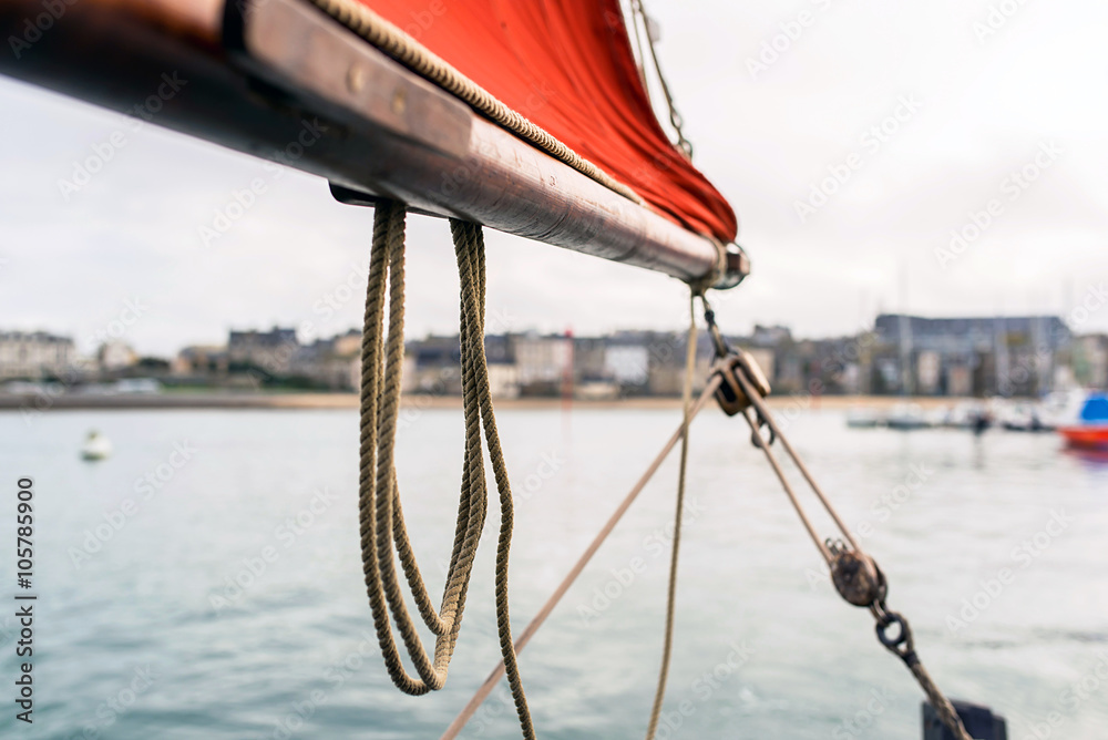 rope fixed on the boom of an old rigging sailing boat during a sea trip ...