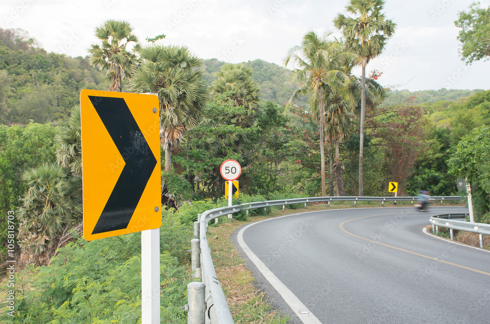 Curve road and right turning signal and Speed limit signs on the way ...