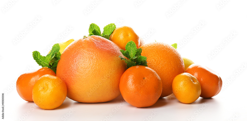 A heap of mixed citrus fruit including a grapefruit, oranges, lemons ...