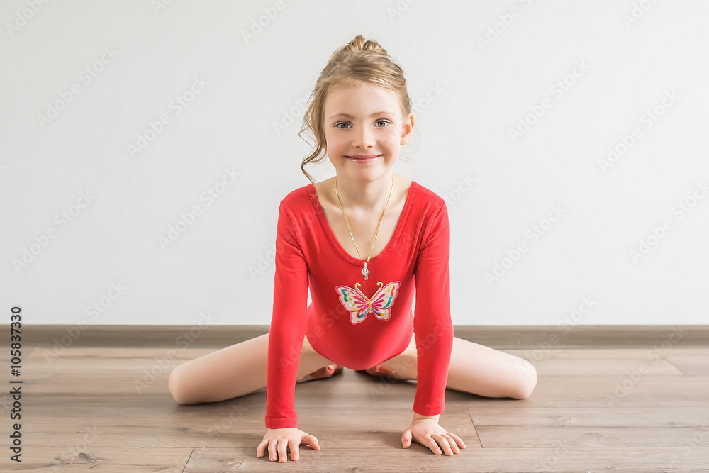 Flexible little girl in red leotard doing gymnastic Stock Photo | Adobe ...