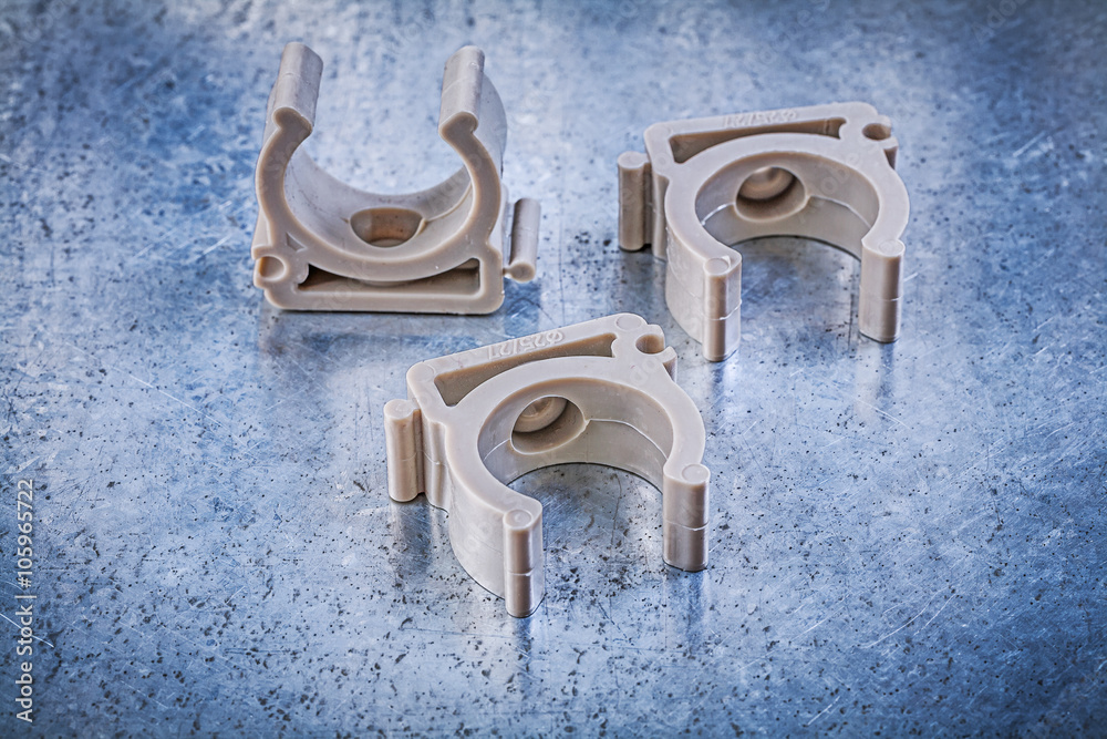 Collection of water pipe clamps on metallic background construct Stock ...