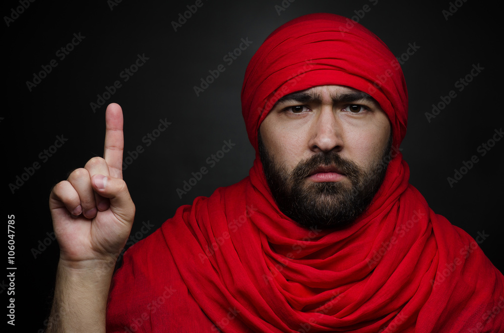 Turkish and Arabic theme: beautiful Arabic man with a beard in a red ...
