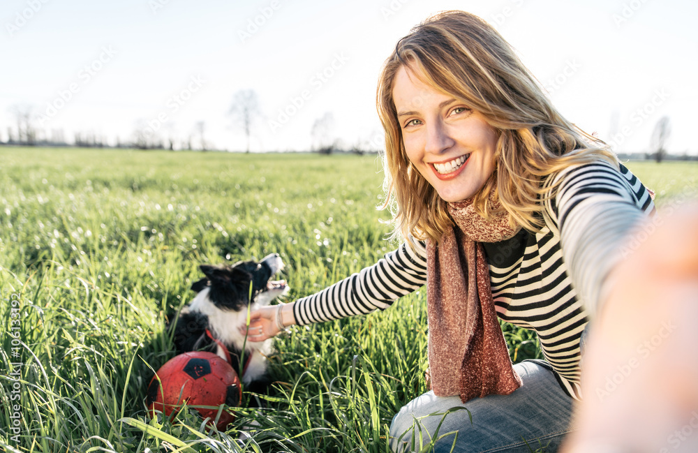 Smiling lady taking free time with her dog Stock Photo | Adobe Stock