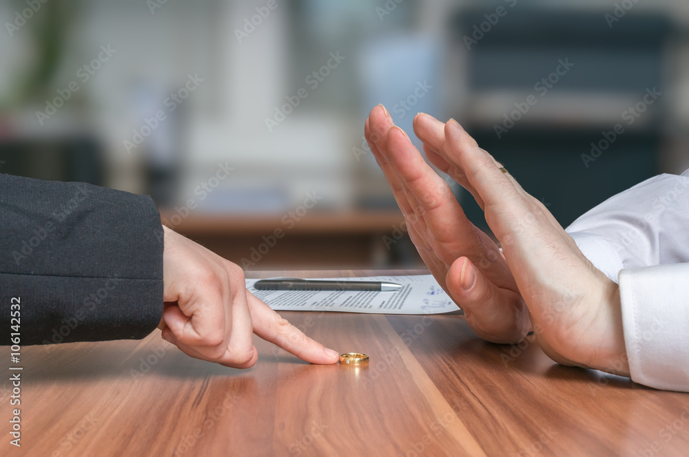 Divorce concept. Wife is returning wedding ring to her disappointed ...