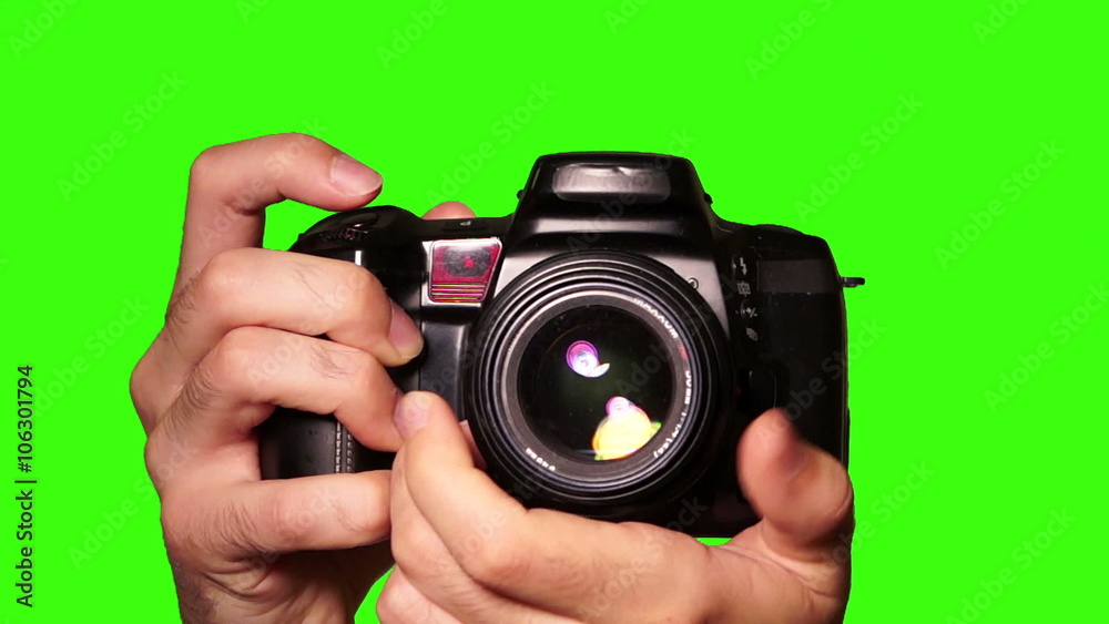 Photographer takes pictures with DSLR camera on a chroma key green ...