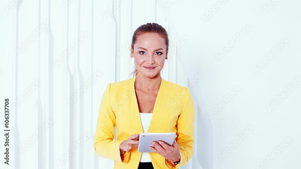 Smiling female model with tablet. The video of modest business woman on ...