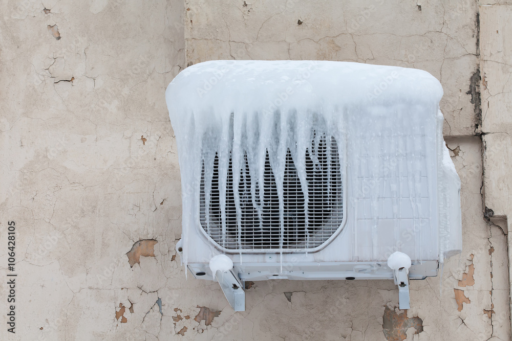 Air conditioner with frozen ice and icicles. Cooling, cold concept ...