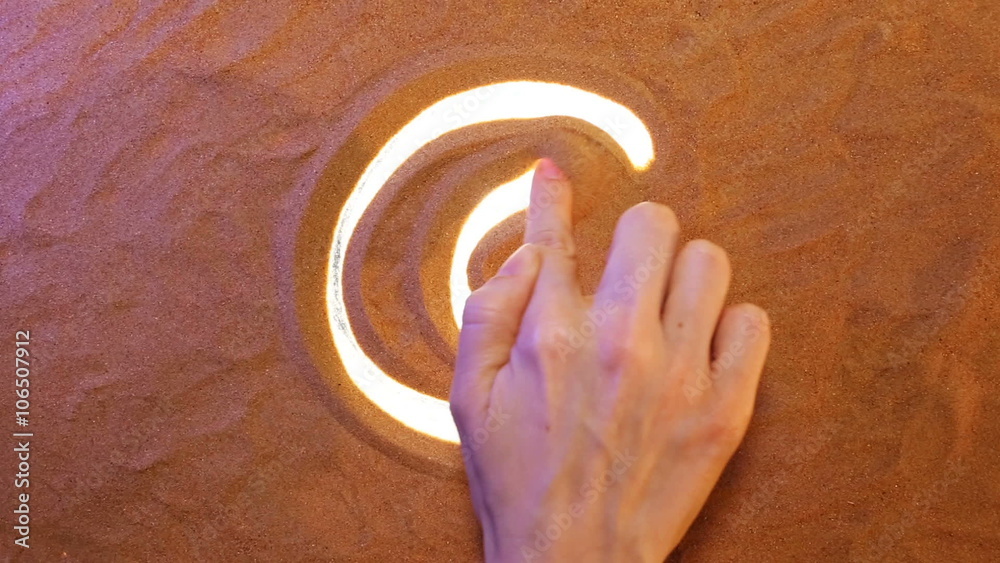 Hand drawing Moon Symbol in the Sand. Beach background. Top view. Spa ...