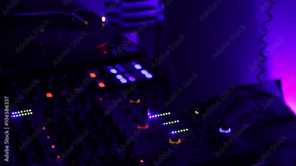 DJ hand pushing buttons on audio mixer. Person playing music. Night ...