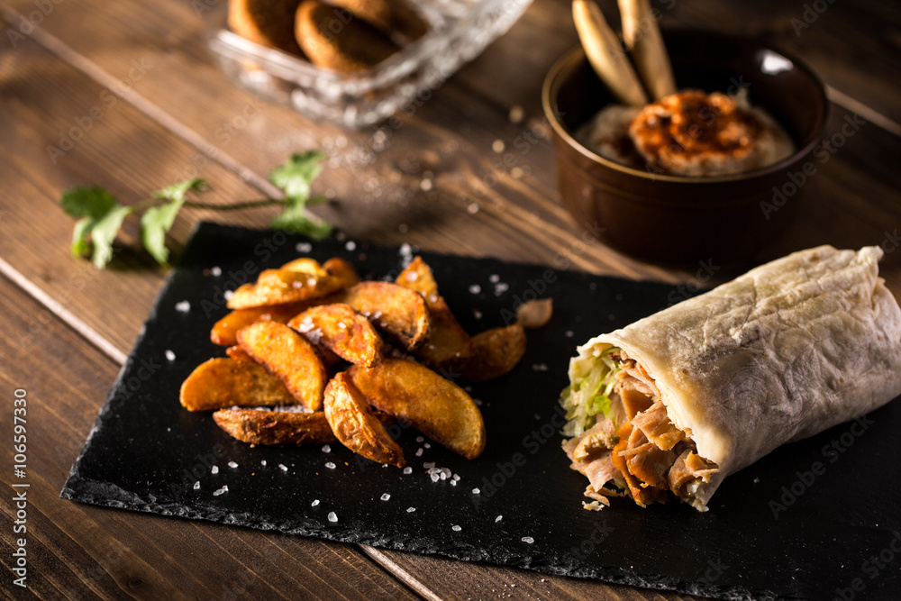 Shawarma with fried potato on table Stock Photo | Adobe Stock