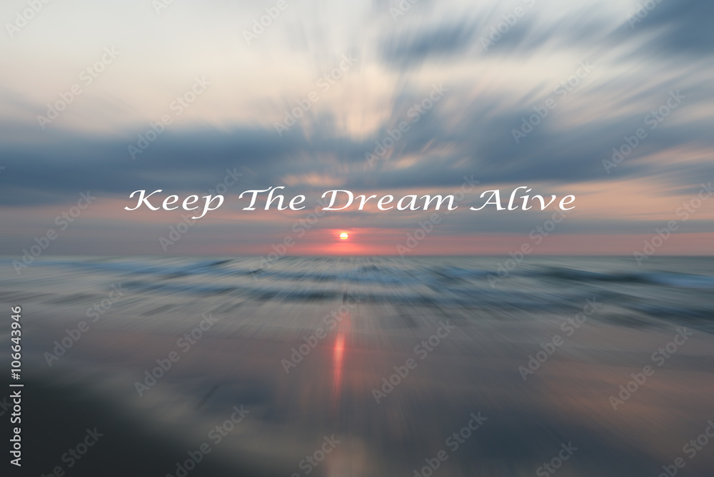 Handwritten text over sunset in zoom effect background, KEEP THE DREAM ...