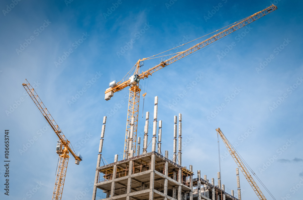 New highrise houses and hoisting tower cranes Stock Photo | Adobe Stock