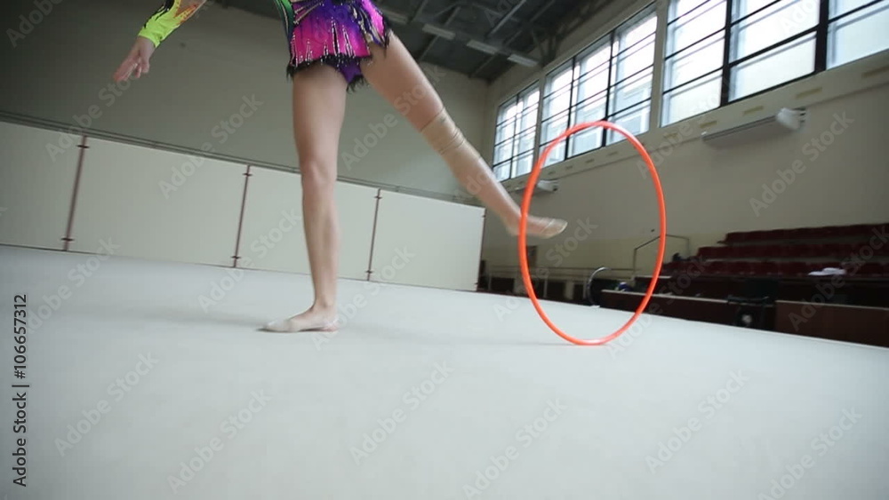 Rhythmic gymnastics: Girl training a gymnastics exercise with a hoop ...