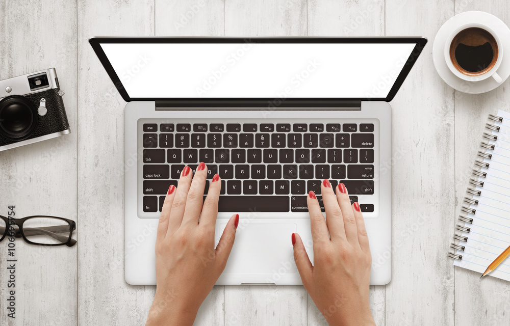 Woman work on laptop with isolated white screen for mockup. Work desk ...