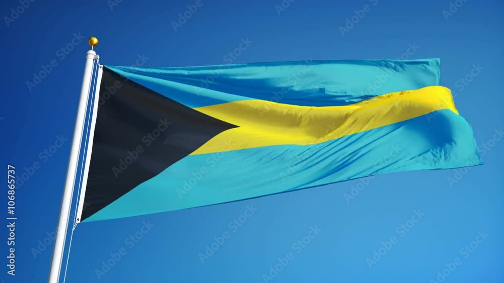 Bahamas flag waving in slow motion against clean blue sky, seamlessly ...
