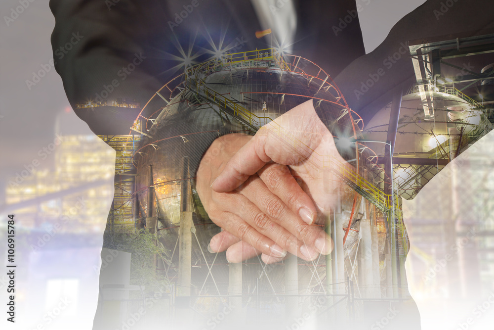 Double exposure of handshake and Electric Generating Factory at night ...