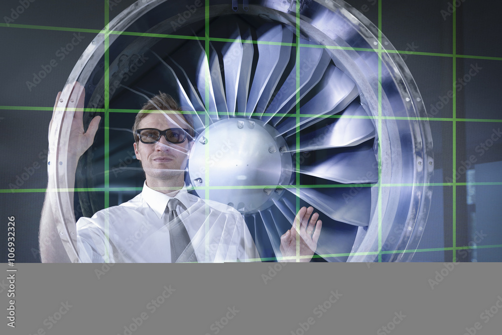 Engineer working with 3D display of Jet Engine, seen through ...
