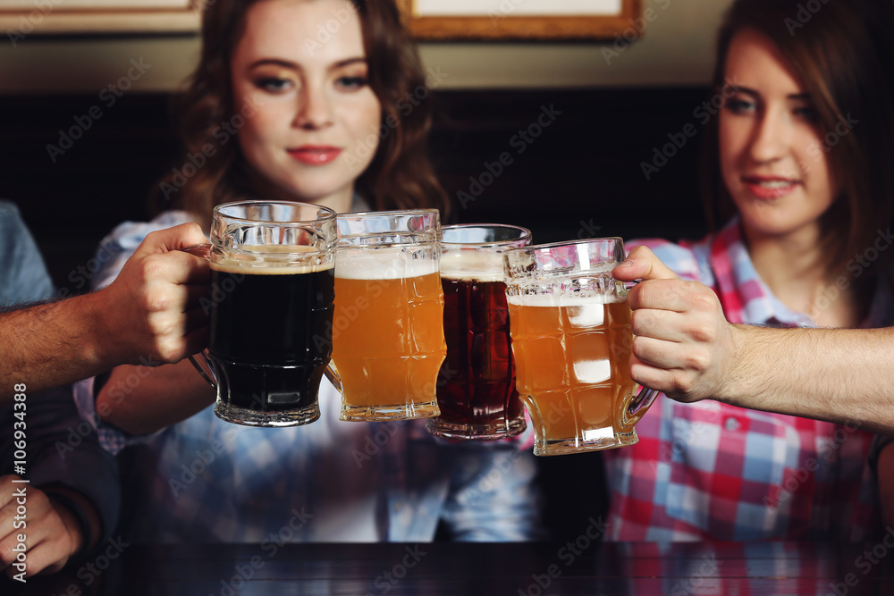 Beautiful girls and their friends drinking beer in pub Stock Photo ...