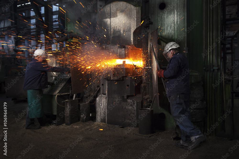 Sparks fly as counterblow hammer forms flight bar, the counterblow ...