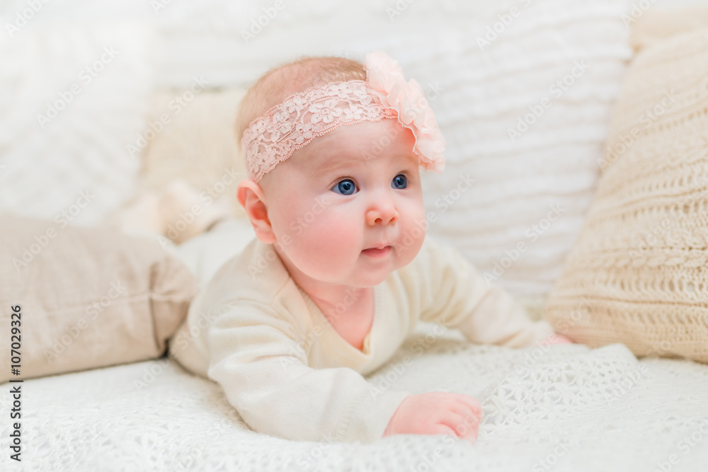 Amazed cute little baby with chubby cheeks wearing white clothes and ...