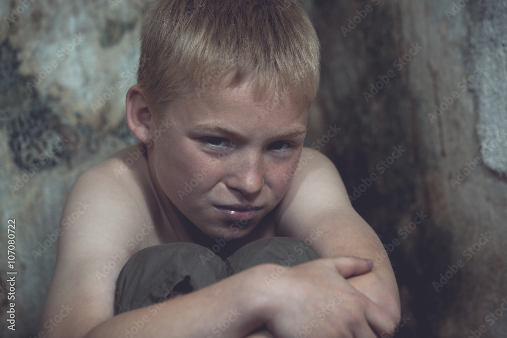 Weeping boy curled up in corner Stock Photo | Adobe Stock