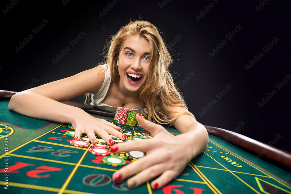 Young pretty women playing roulette wins at the casino Stock Photo ...