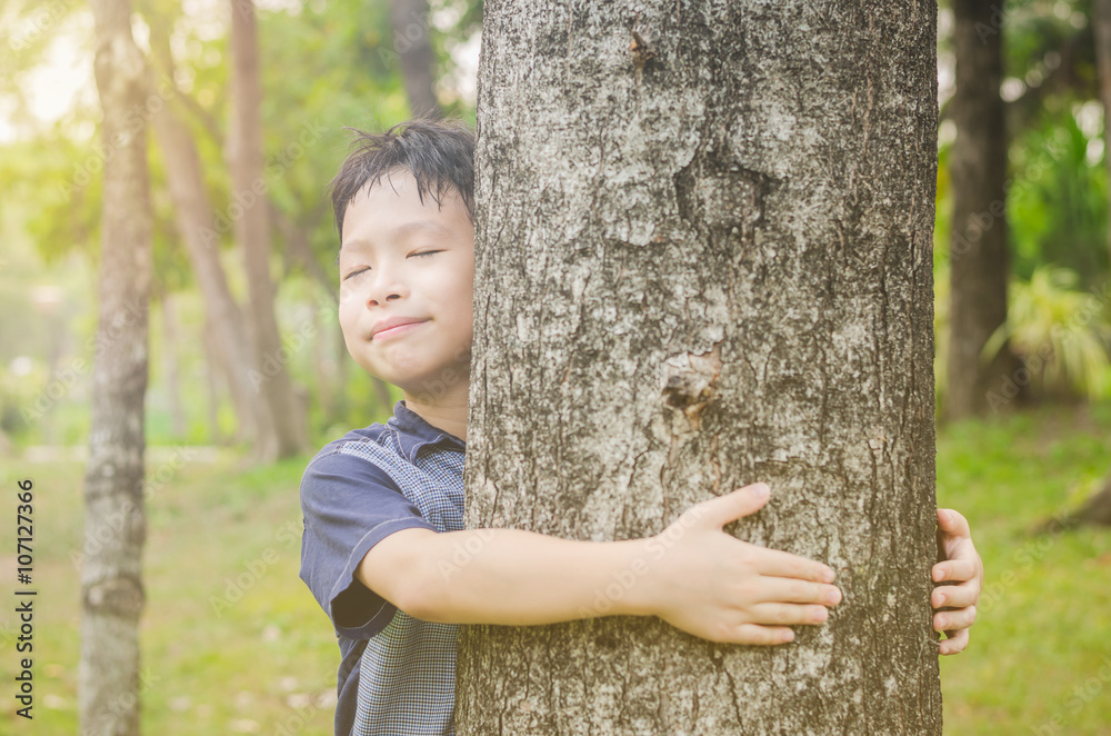 Young Boy Hugging A Tree