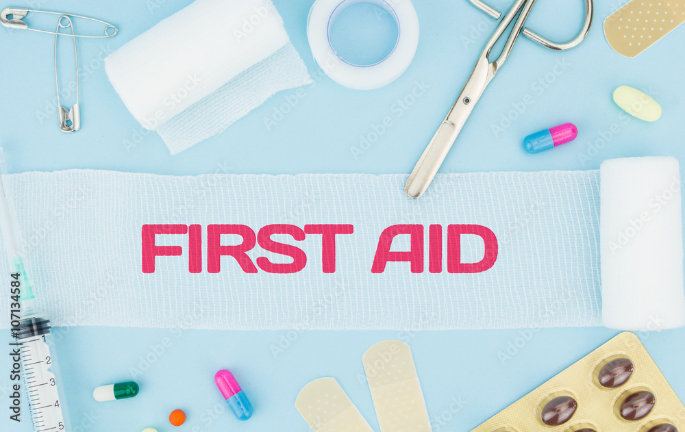 Medical equipment, on light blue background with First Aid text on ...