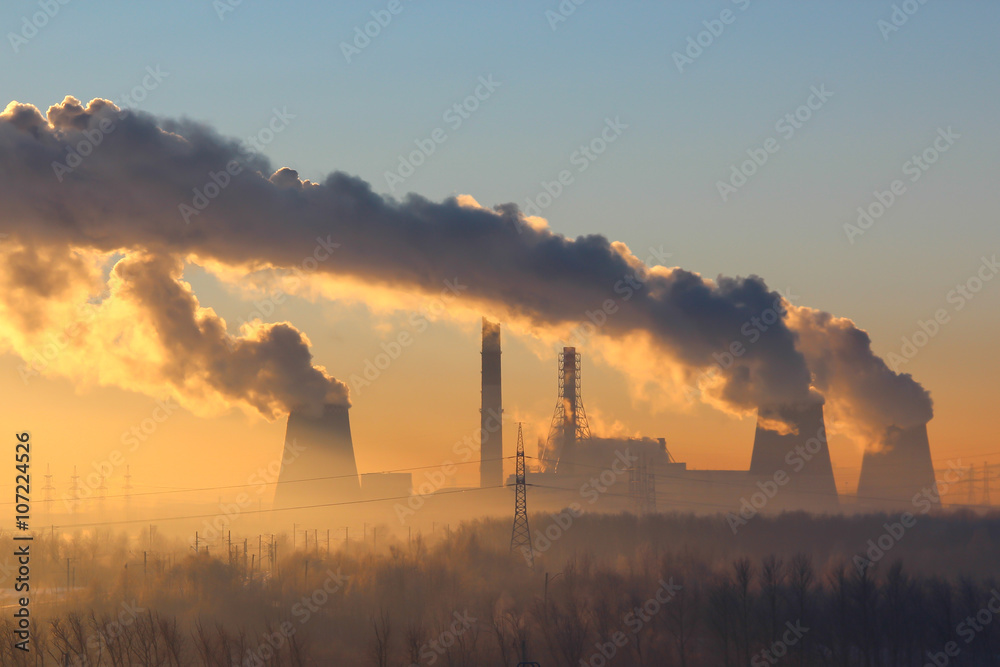 Foggy landscape: the power plant with huge cooling towers with thick ...