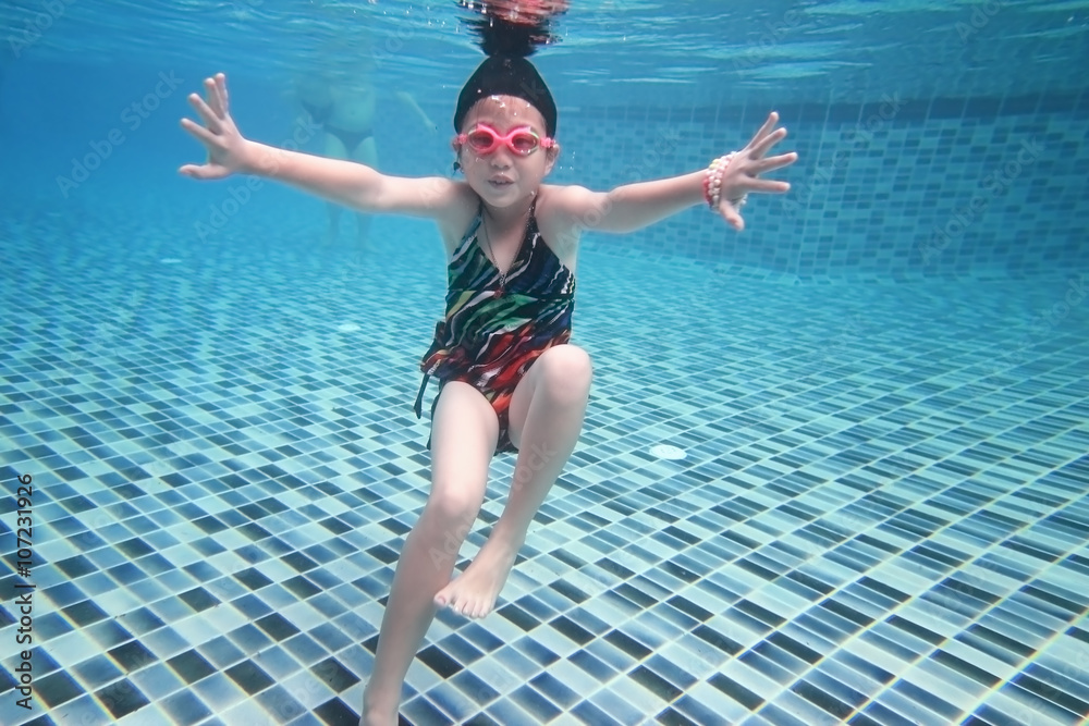 little asian girl underwater in swimming pool Stock Photo | Adobe Stock