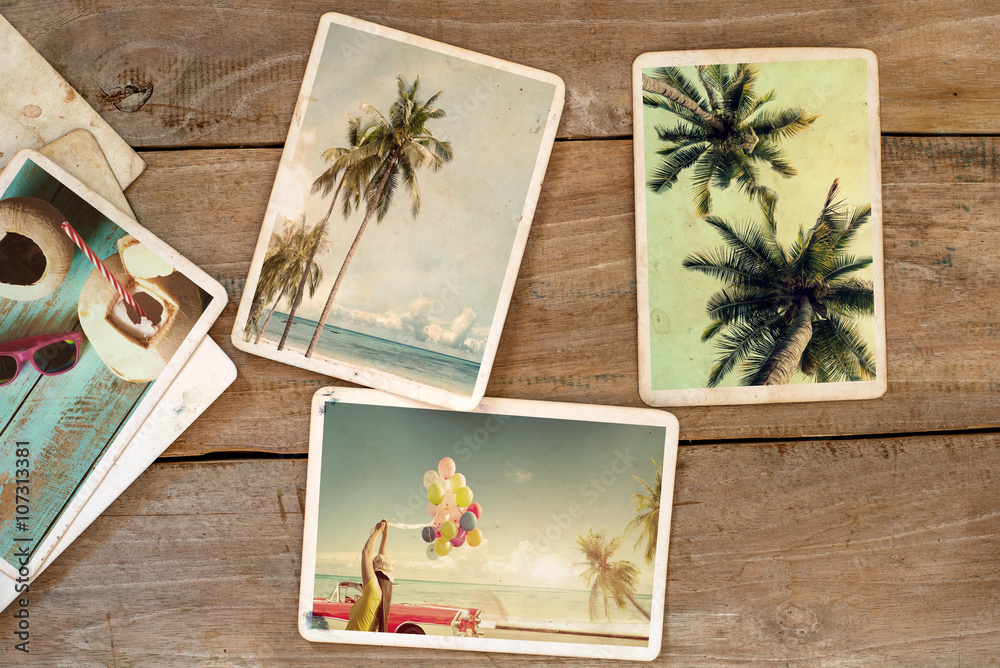 Summer photo album on wood table. instant photo of polaroid camera ...