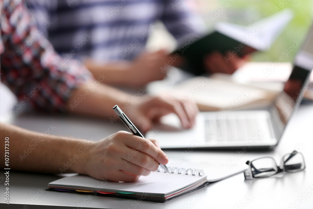 Student's hand writing in exercise book at the table Stock Photo ...