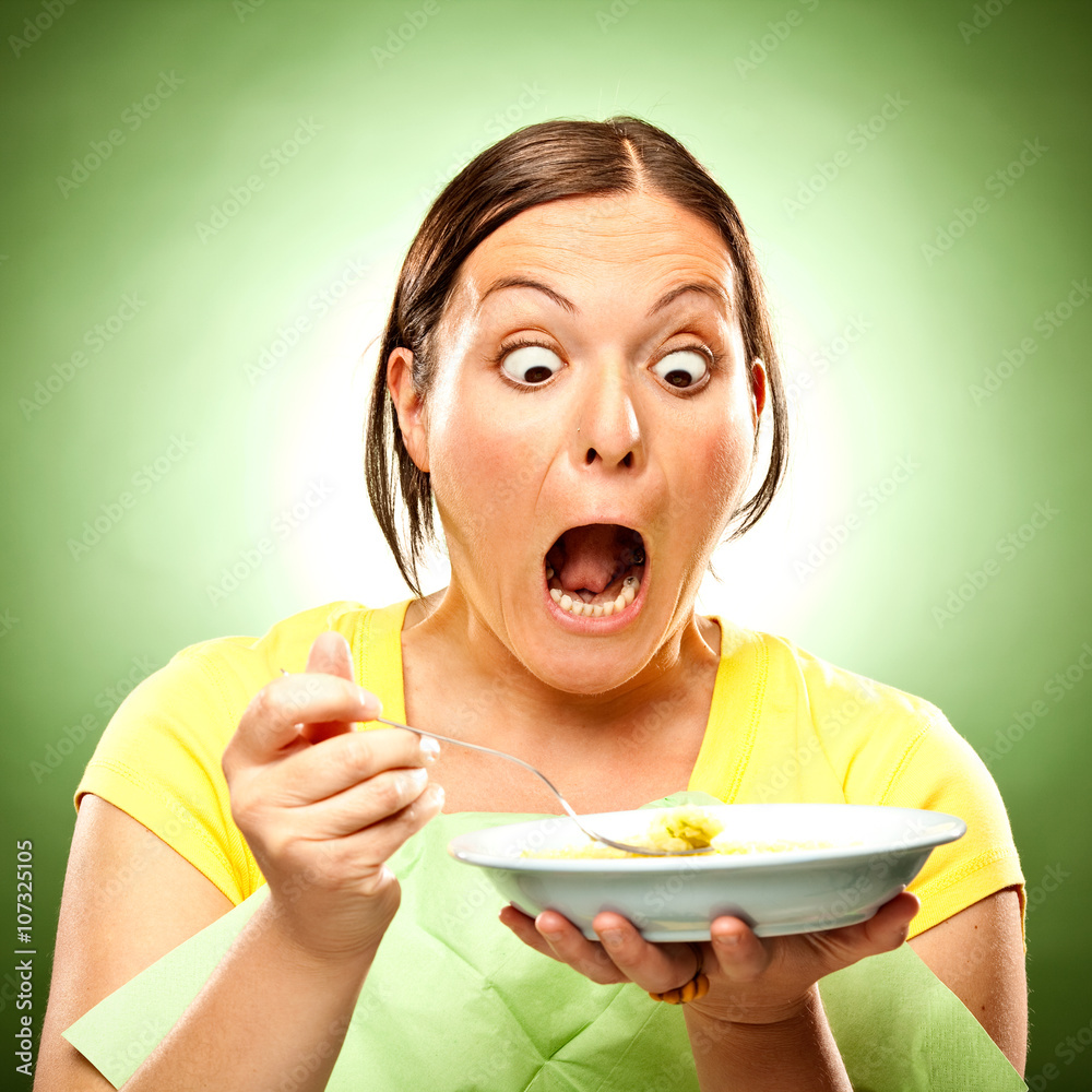 funny shocked girl eat standing with green background Stock Photo ...