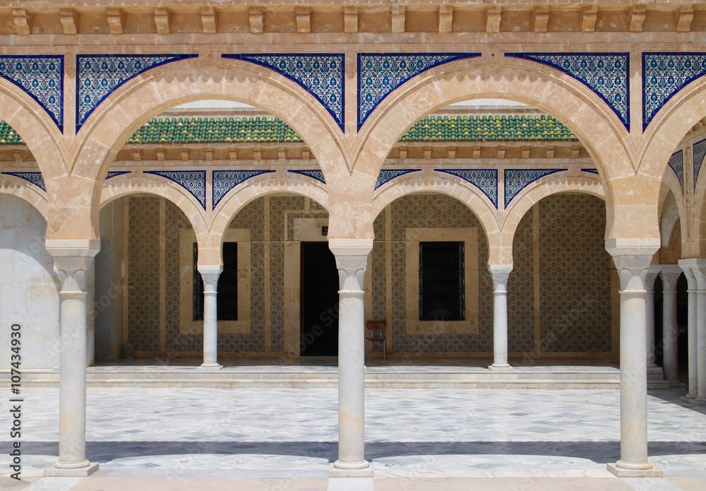 Patterned pillars of old historic mosque with patterns and windows and ...
