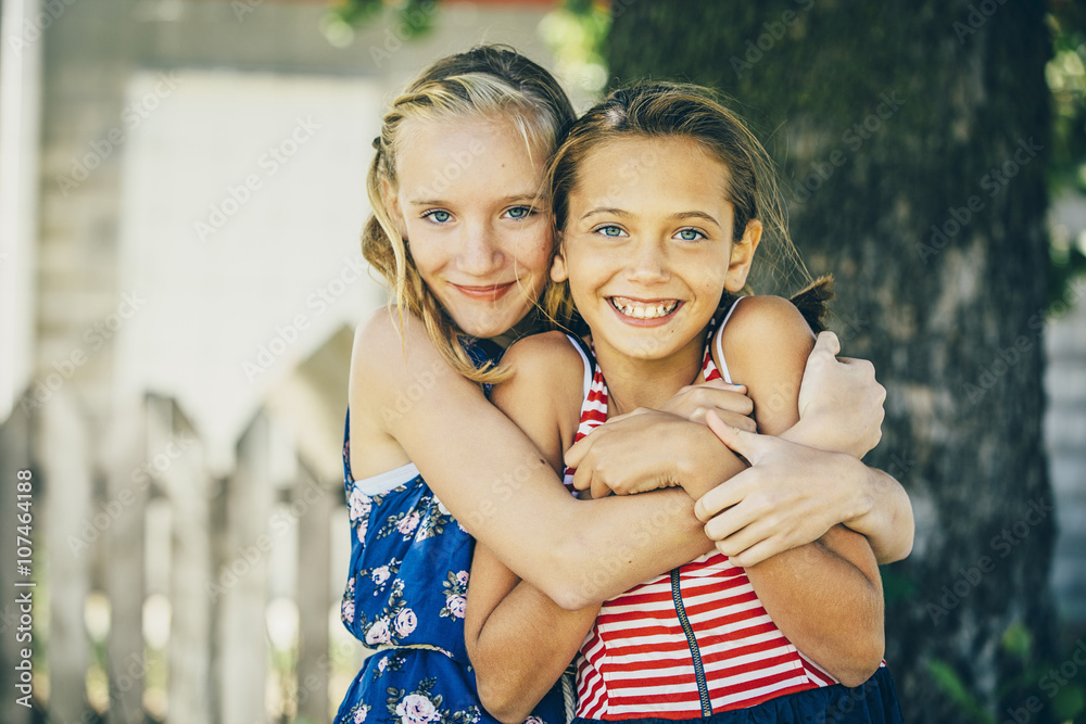 Girls hugging outdoors Stock Photo | Adobe Stock