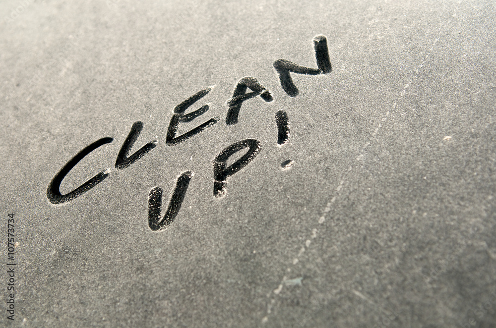Car dust word on dirty rear window of the car and inscription CLEAN UP ...