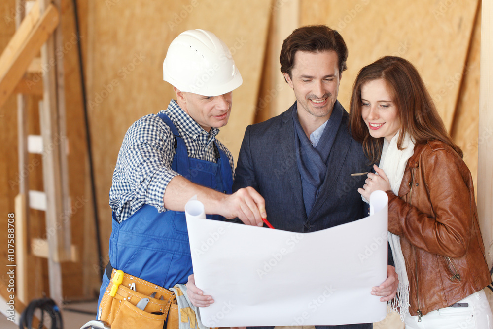 Worker shows house design plans Stock Photo | Adobe Stock