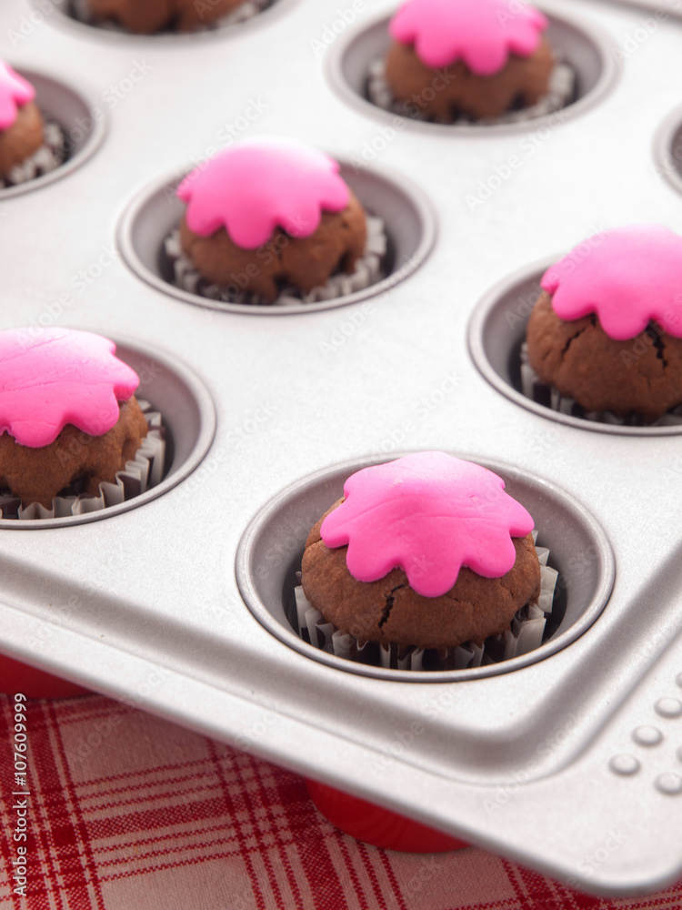 Glazed cupcakes with white and purple glazing on a baking tray Stock ...