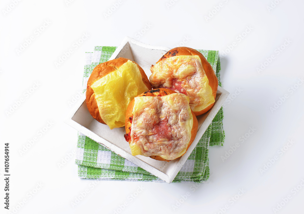 Cheese and ham topped bread rolls Stock Photo | Adobe Stock