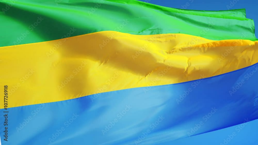Gabon flag waving in slow motion against clean blue sky, seamlessly ...