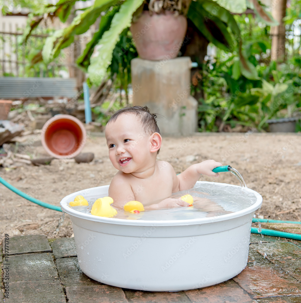 Top view Asian baby boy outdoor bathing in the white bathtub . H Stock ...